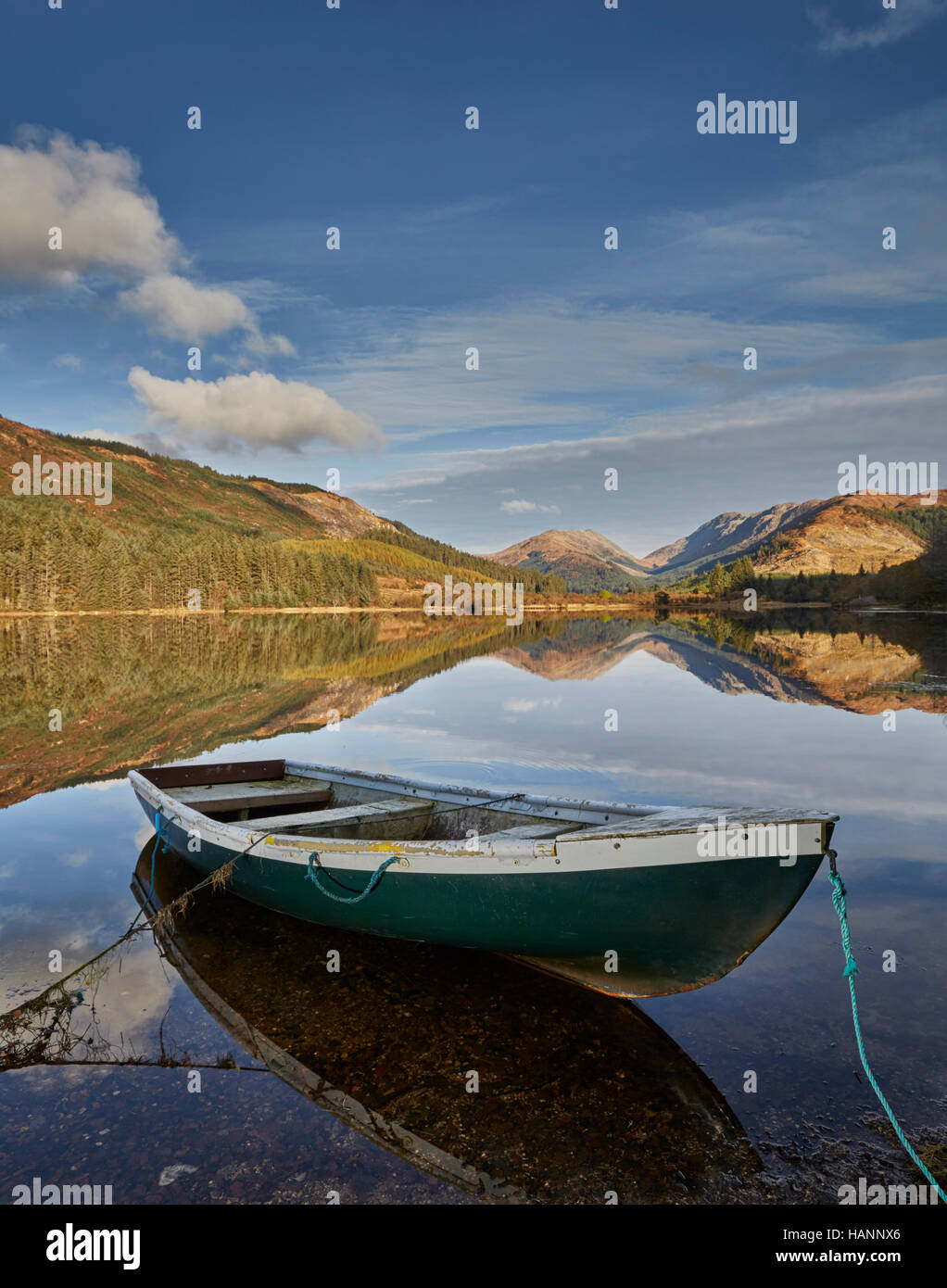 A rowing boat moored in a loch in the highlands Scotland with the ...