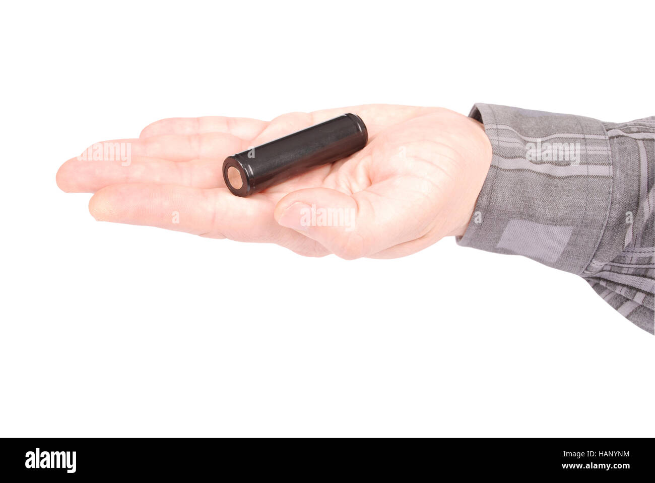 A male hand holding black battery, isolated on white with clipping path ...