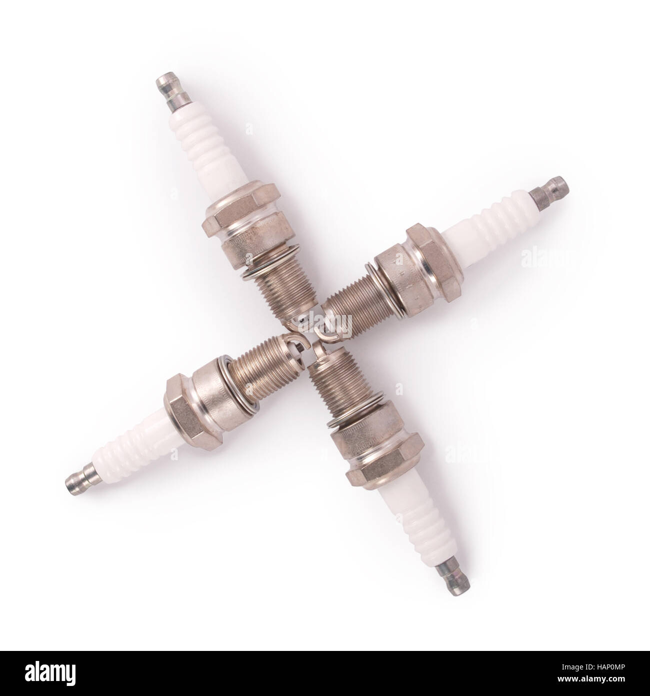 Four new spark plugs on a white background with soft shadow Stock Photo ...