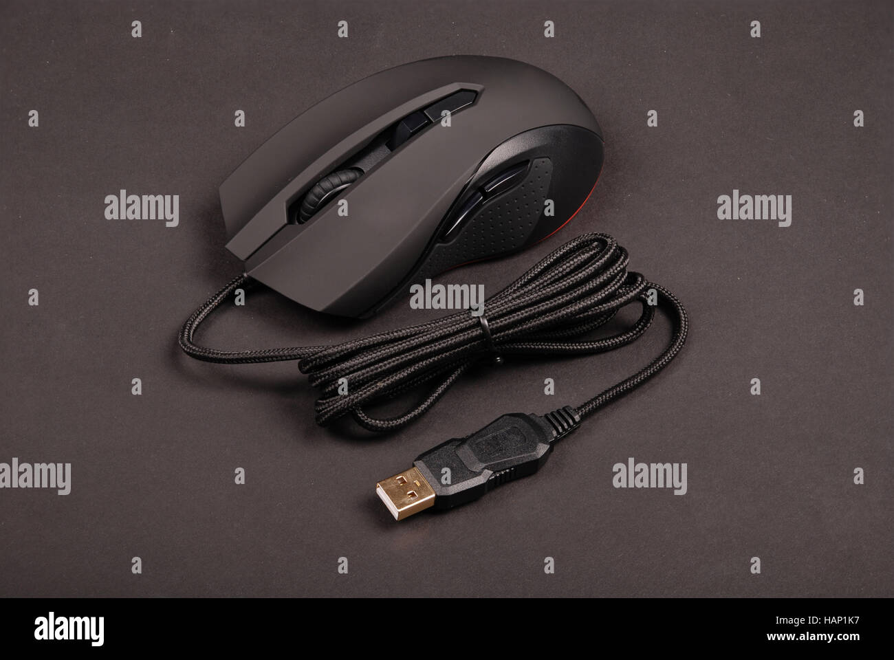 Black computer optical mouse isolated on black background with soft ...