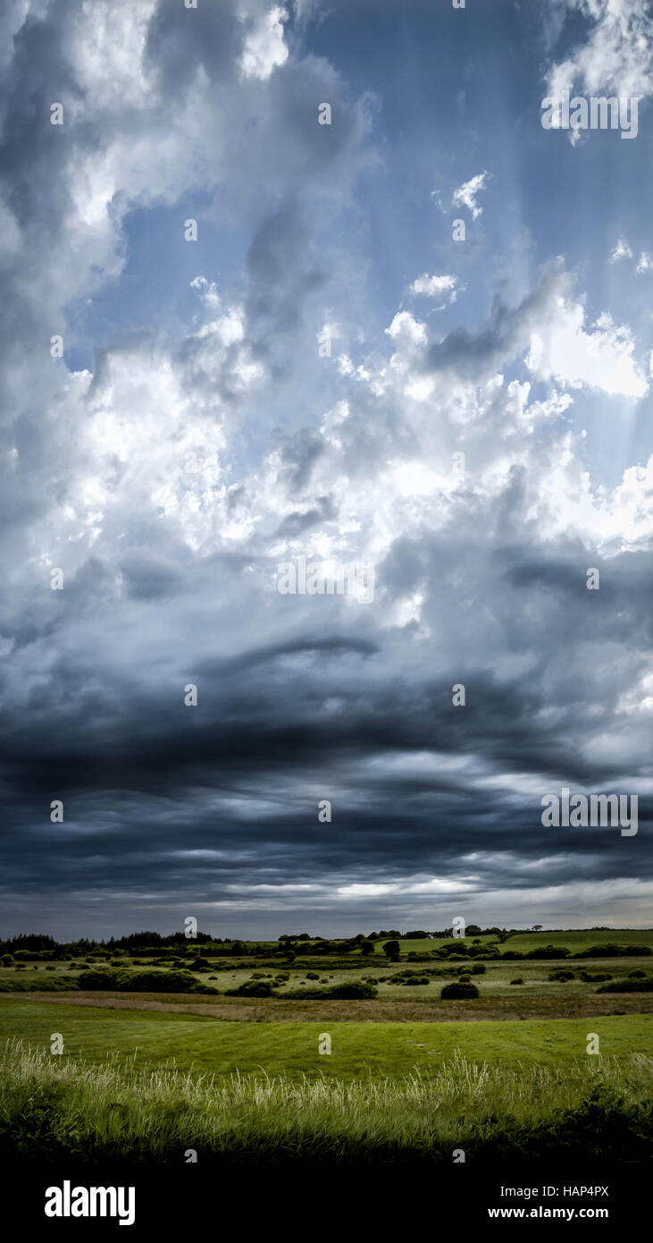 dark stormy clouds over rolling fields portrait Stock Photo - Alamy