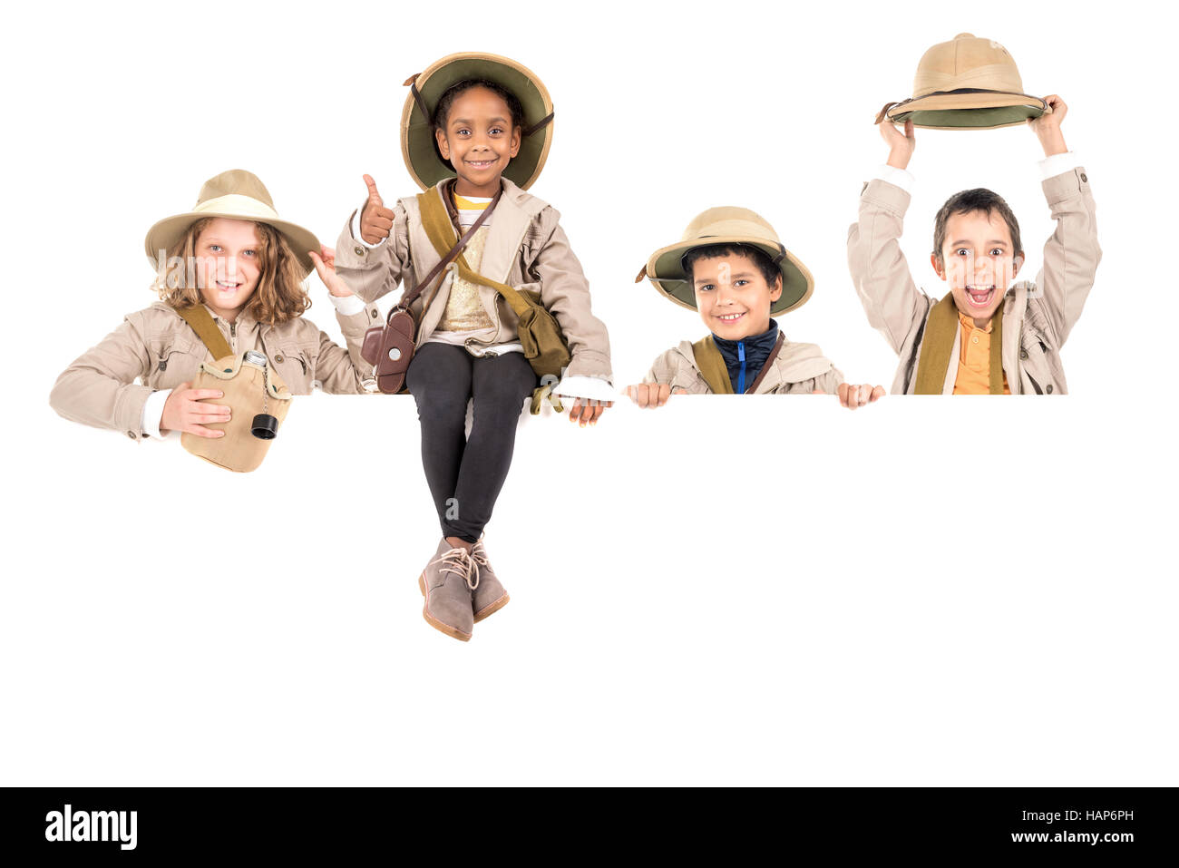 Children's group with safari clothes and gear over a white board Stock ...