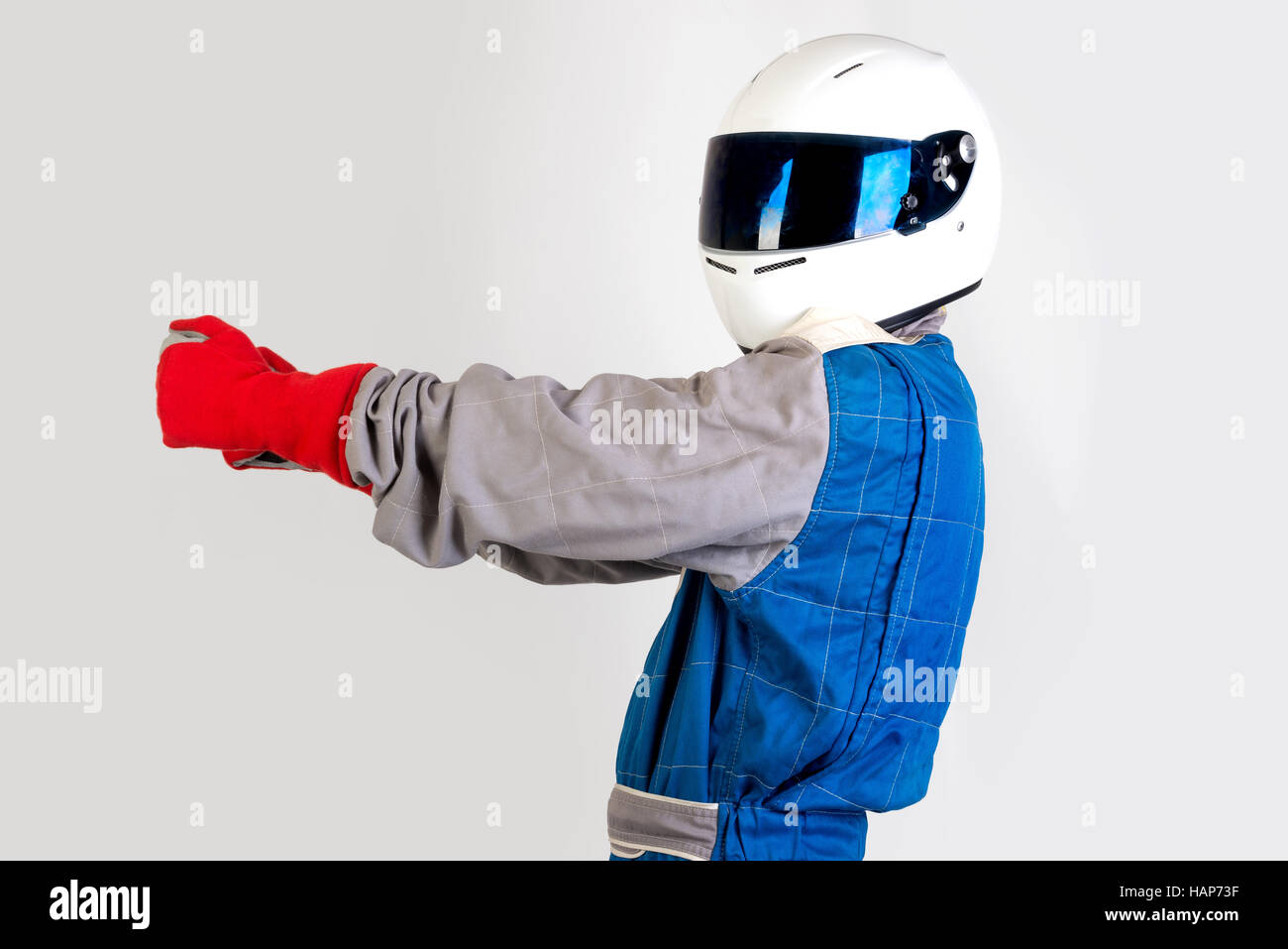 Racing driver posing with helmet isolated in white Stock Photo - Alamy