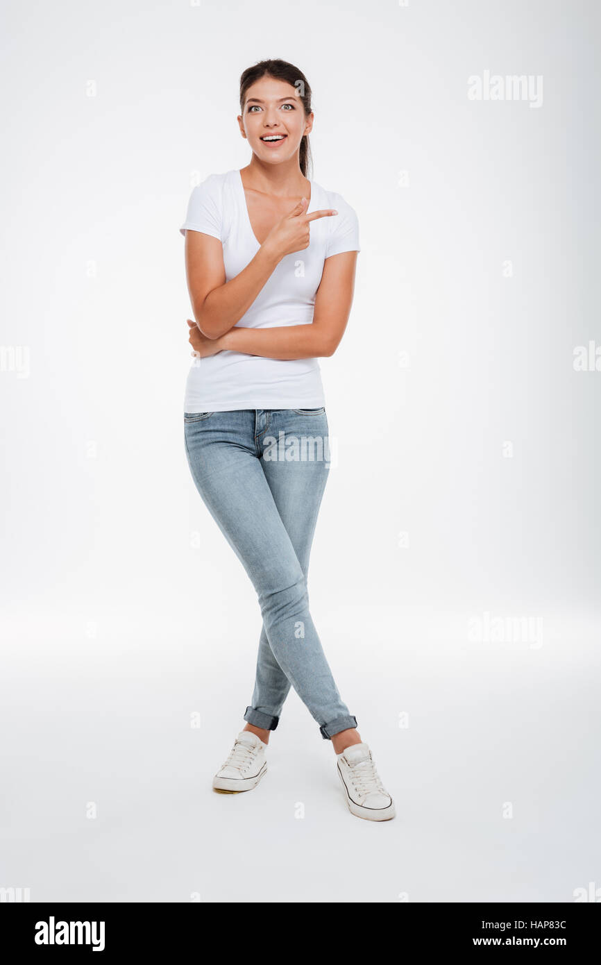 Full length happy model in t-shirt and jeans. isolated white background ...