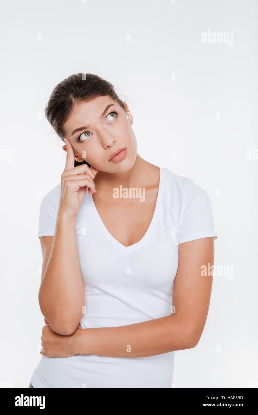 Thoughtful model in studio looking up. isolated white background Stock ...