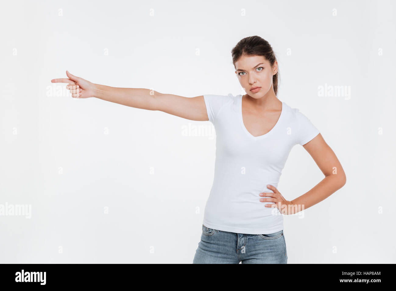 Young model in t-shirt showing away. isolated white background Stock ...