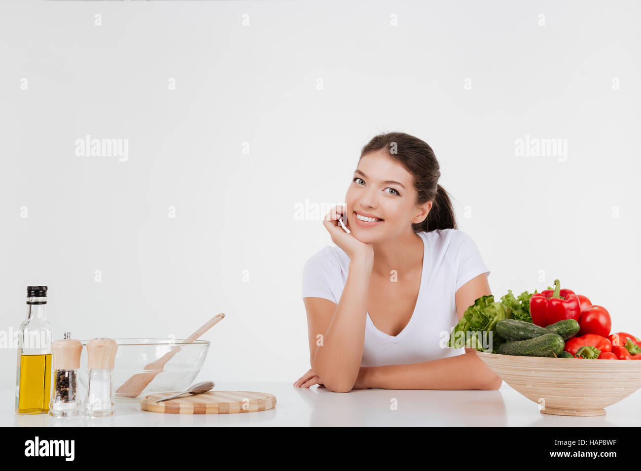 Happy woman cooking with vegetables. Isolated on white background Stock ...