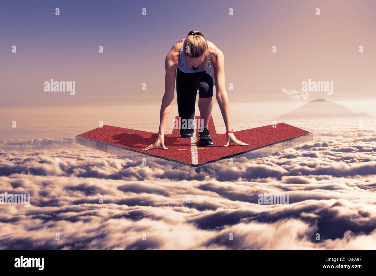 Female runner kneels in start position on a floating red arrow platform ...