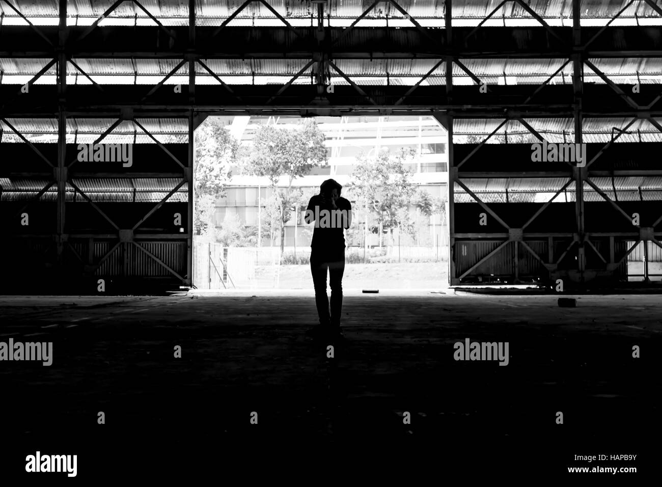 Mysterious man standing in Black and White Stock Photos & Images - Alamy