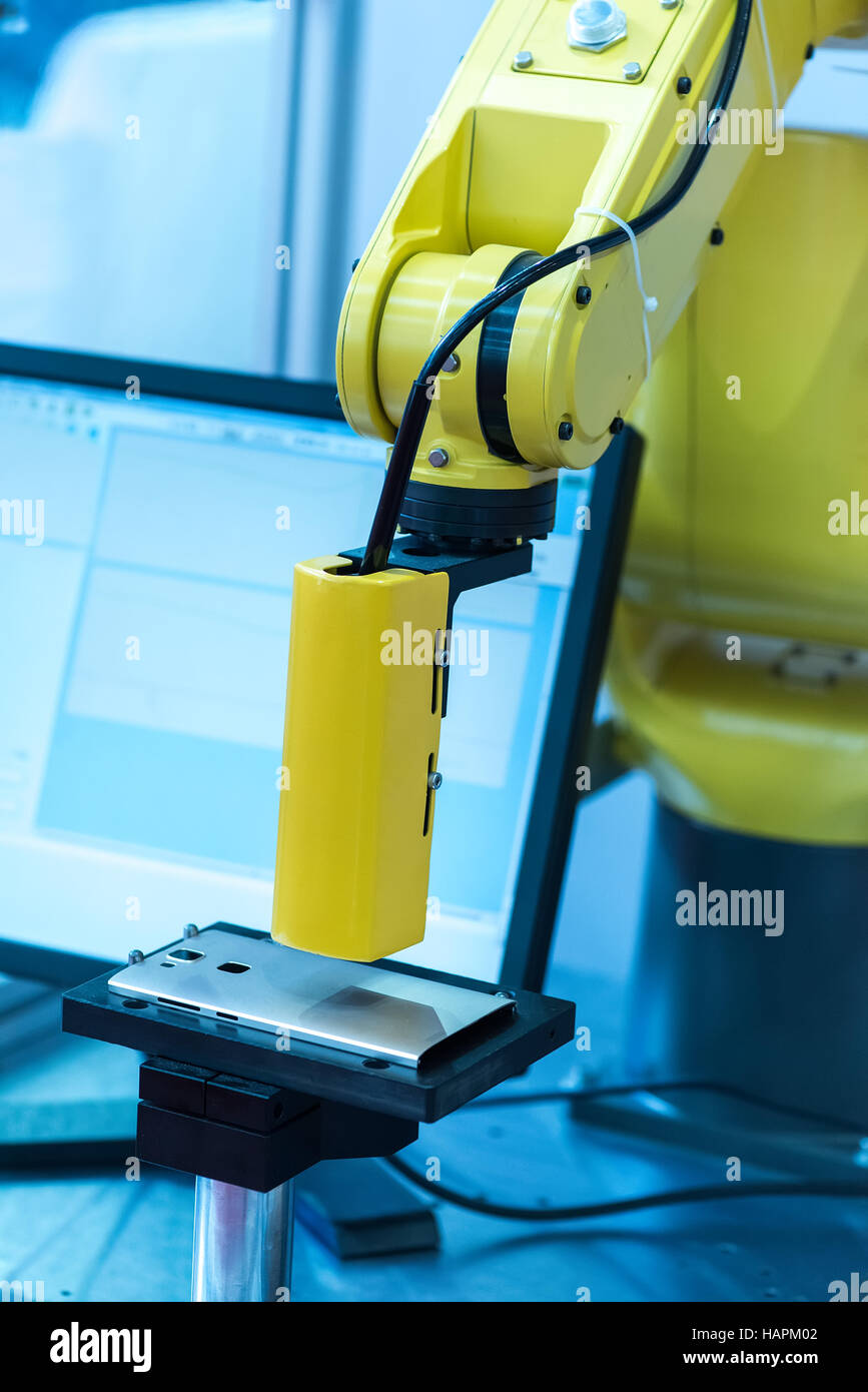 Industrial robot working in phone factory Stock Photo - Alamy