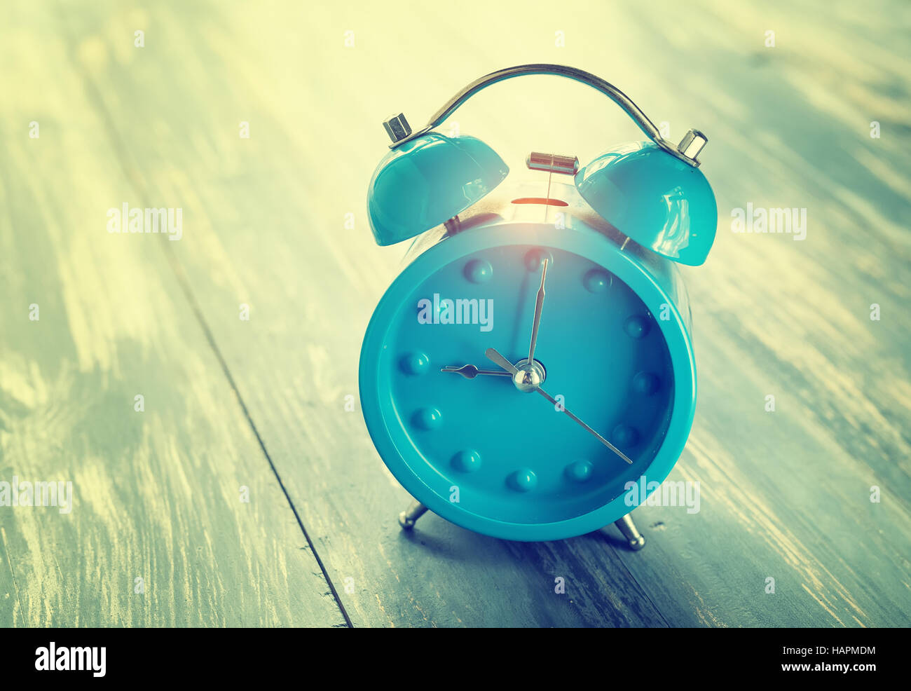 blue clock on antique rustic wood background Stock Photo - Alamy
