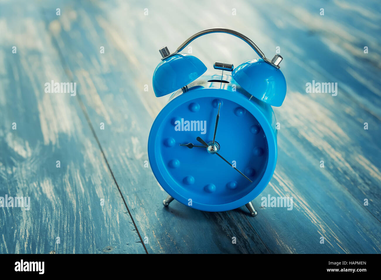 blue clock on antique rustic wood background Stock Photo - Alamy