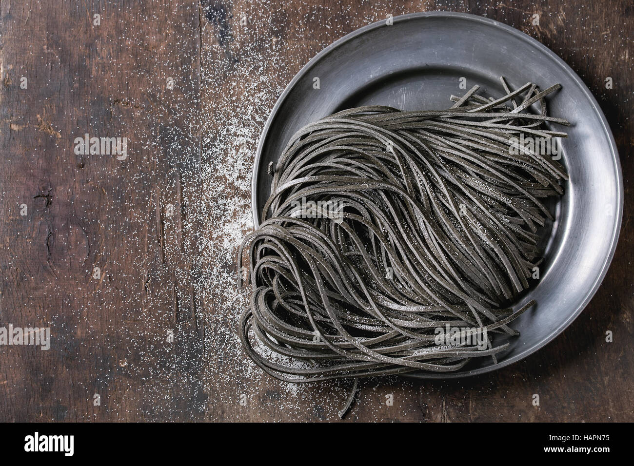 Raw black spaghetti pasta Stock Photo - Alamy