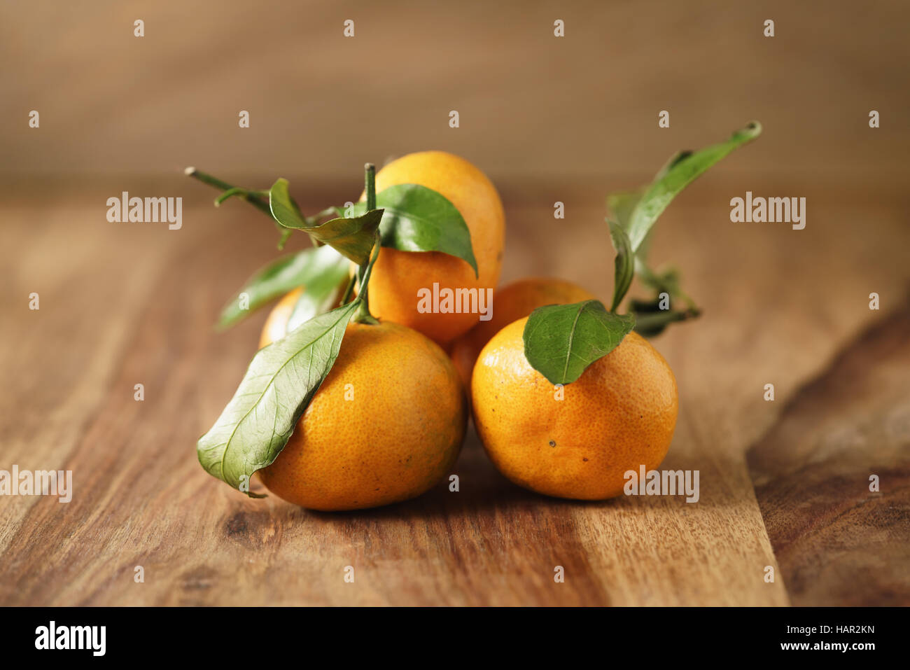 organic fresh tangerines with leaves on wooden table Stock Photo - Alamy