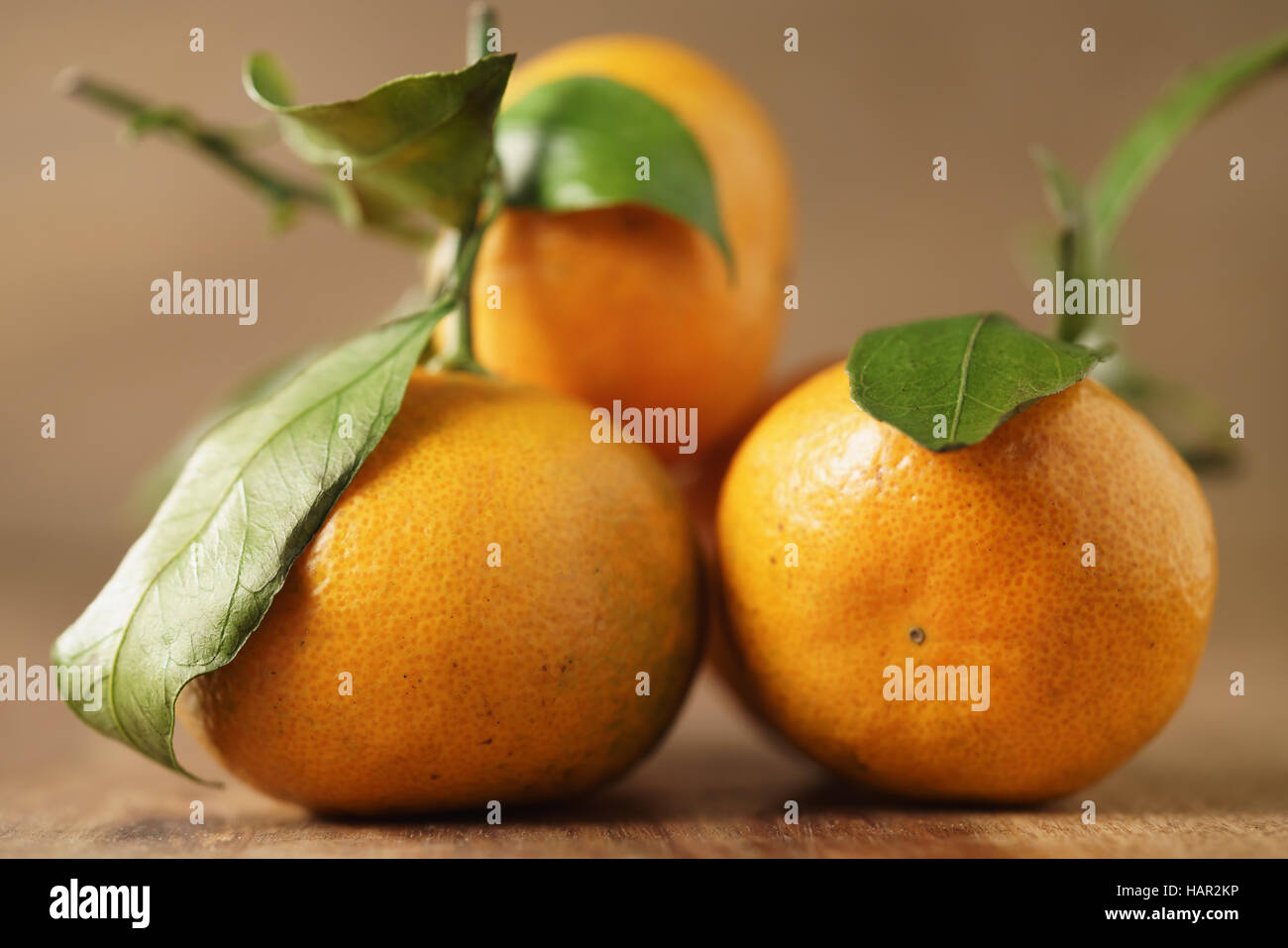 organic fresh tangerines with leaves on wooden table Stock Photo - Alamy