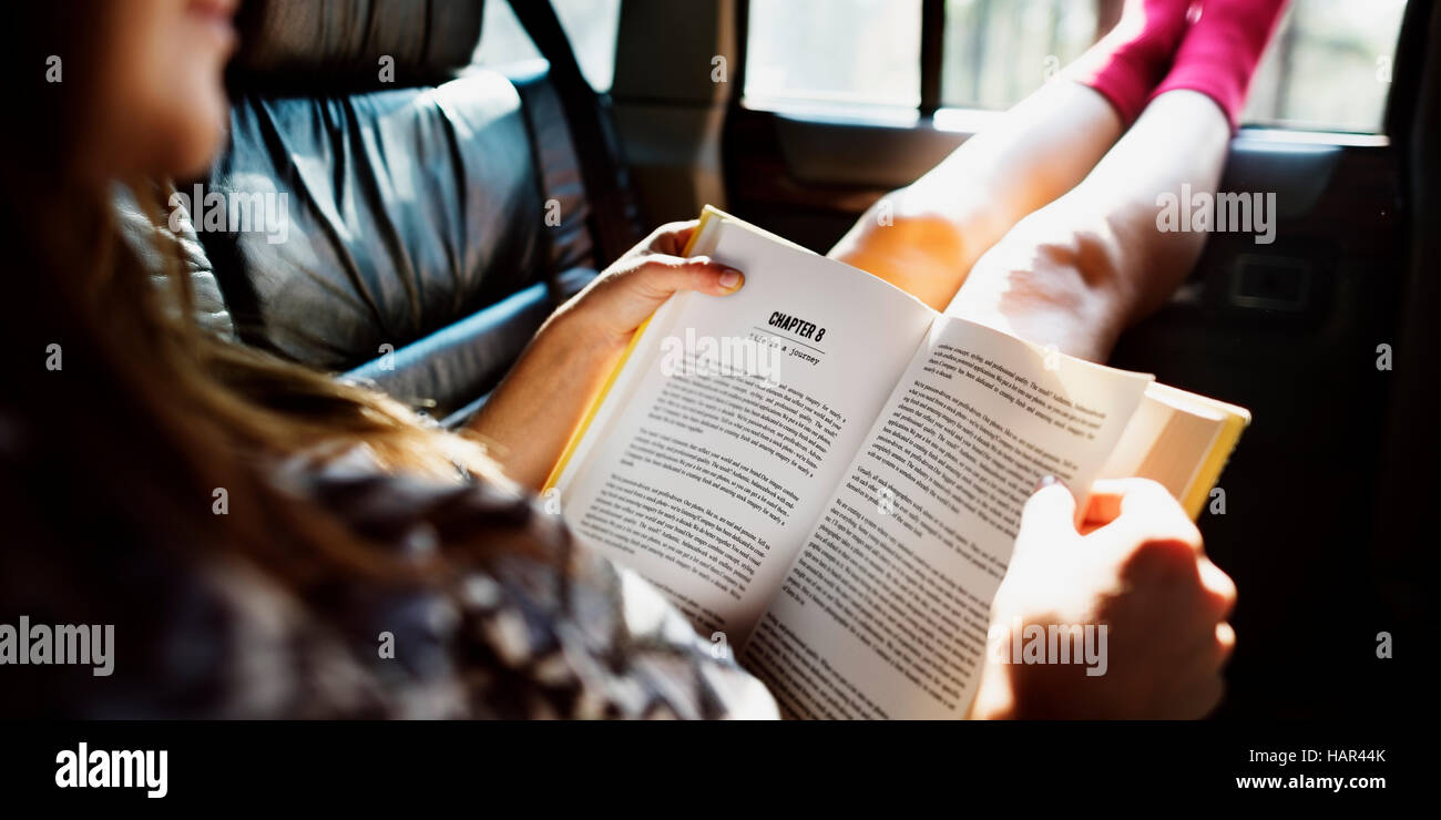 Girl Reading Book Inside Car Concept Stock Photo - Alamy