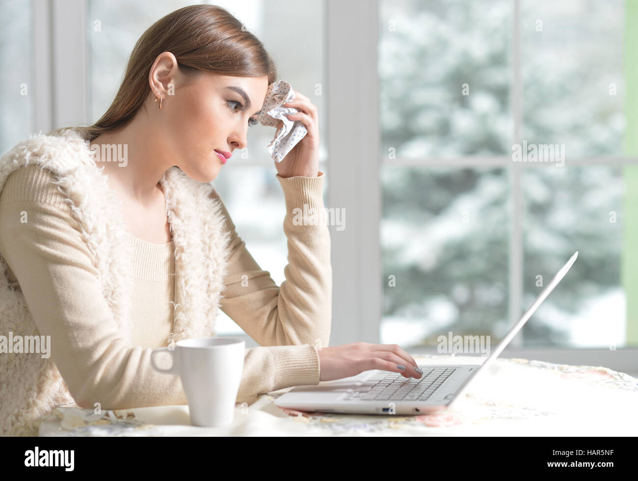 Sick girl with laptop Stock Photo - Alamy