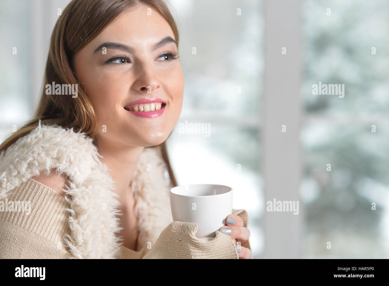 Girl drinking tea Stock Photo - Alamy