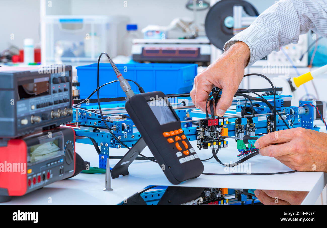 Adjusting an industrial robot with a CNC computer control Stock Photo ...