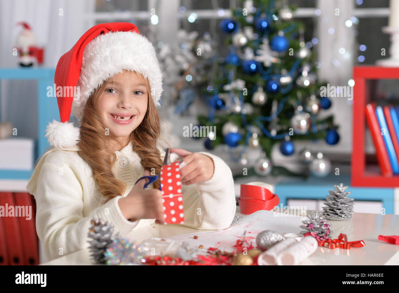 Little girl in Santa hat Stock Photo - Alamy