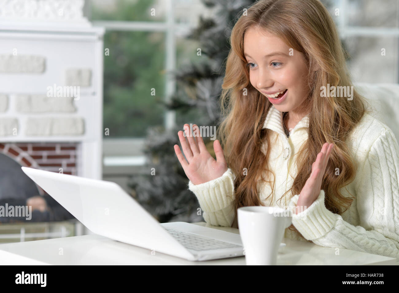 Surprised girl with laptop Stock Photo - Alamy