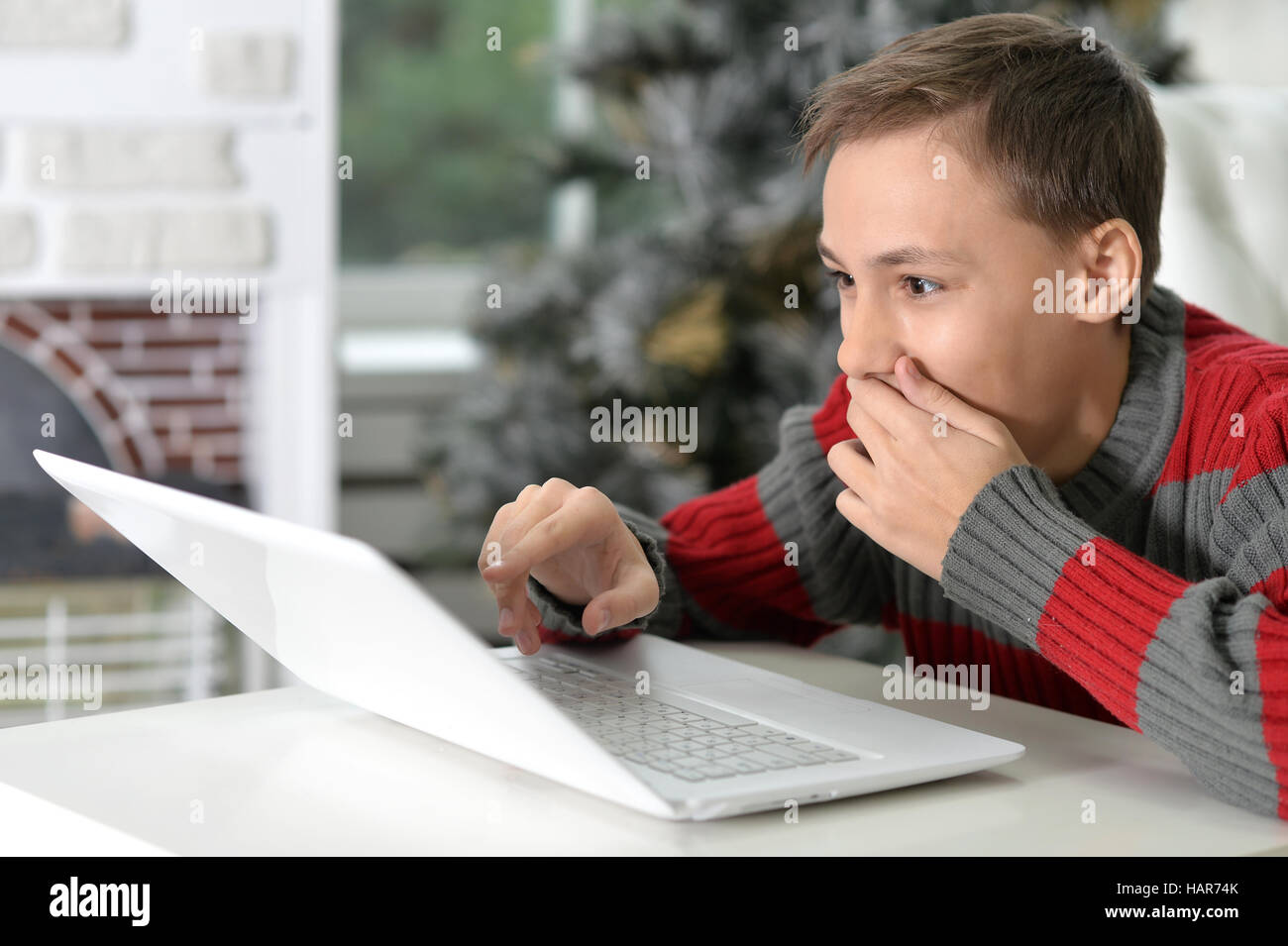 Surprised boy with laptop Stock Photo - Alamy