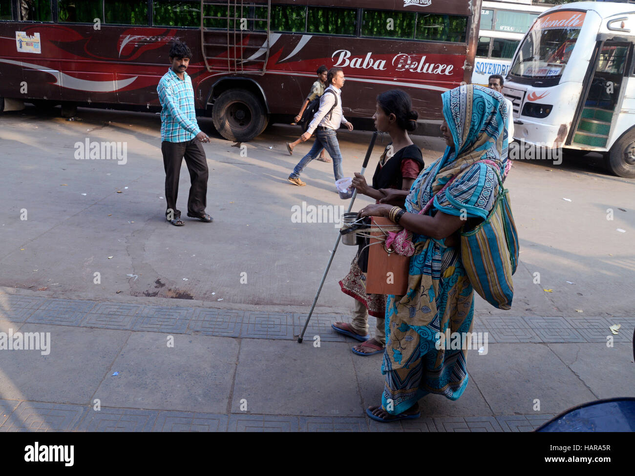 Kolkata, India. 02nd Dec, 2016. A blind girl begs with her mother for ...