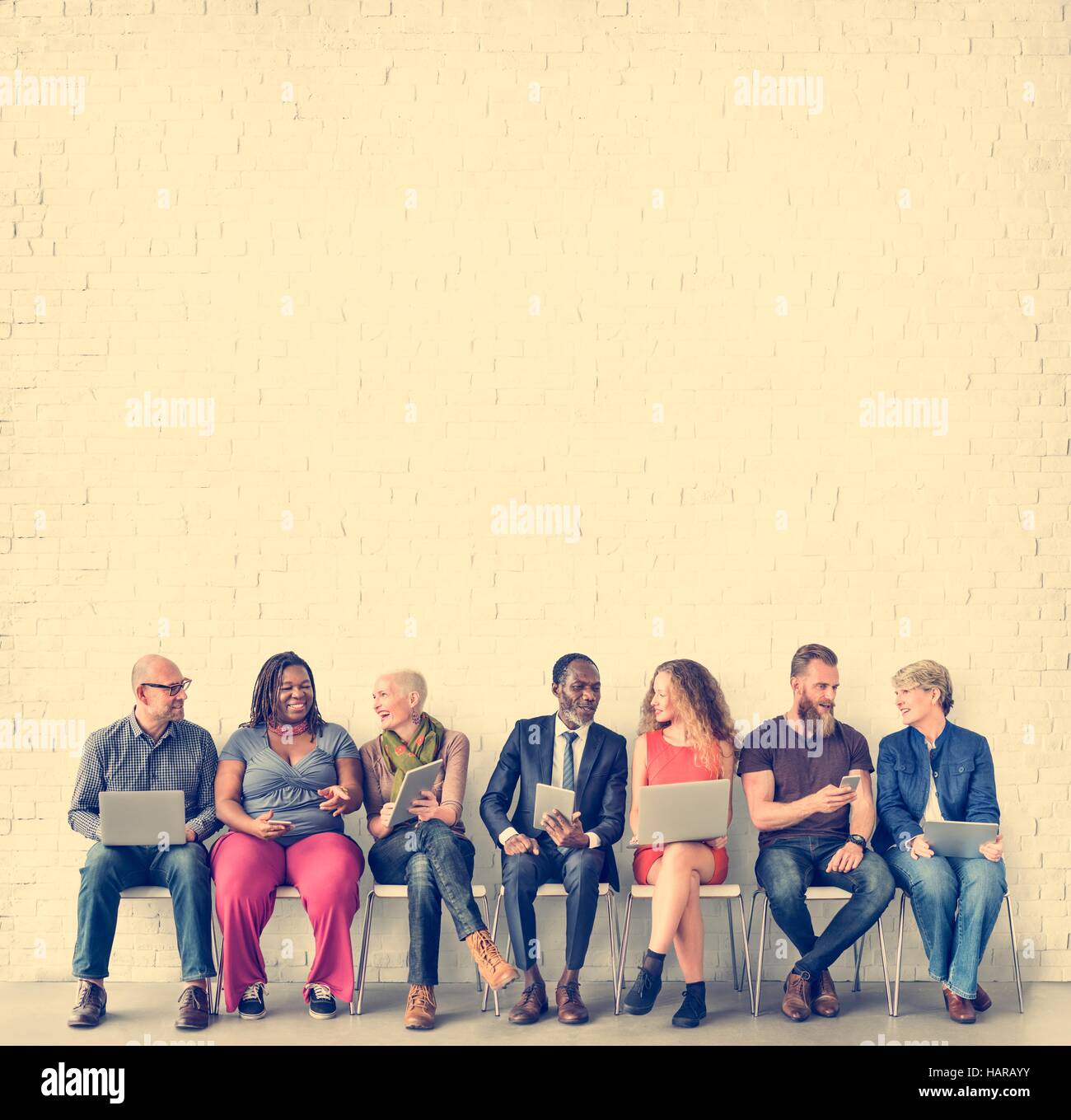 Diverse Group of People Community Togetherness Technology Sitting ...