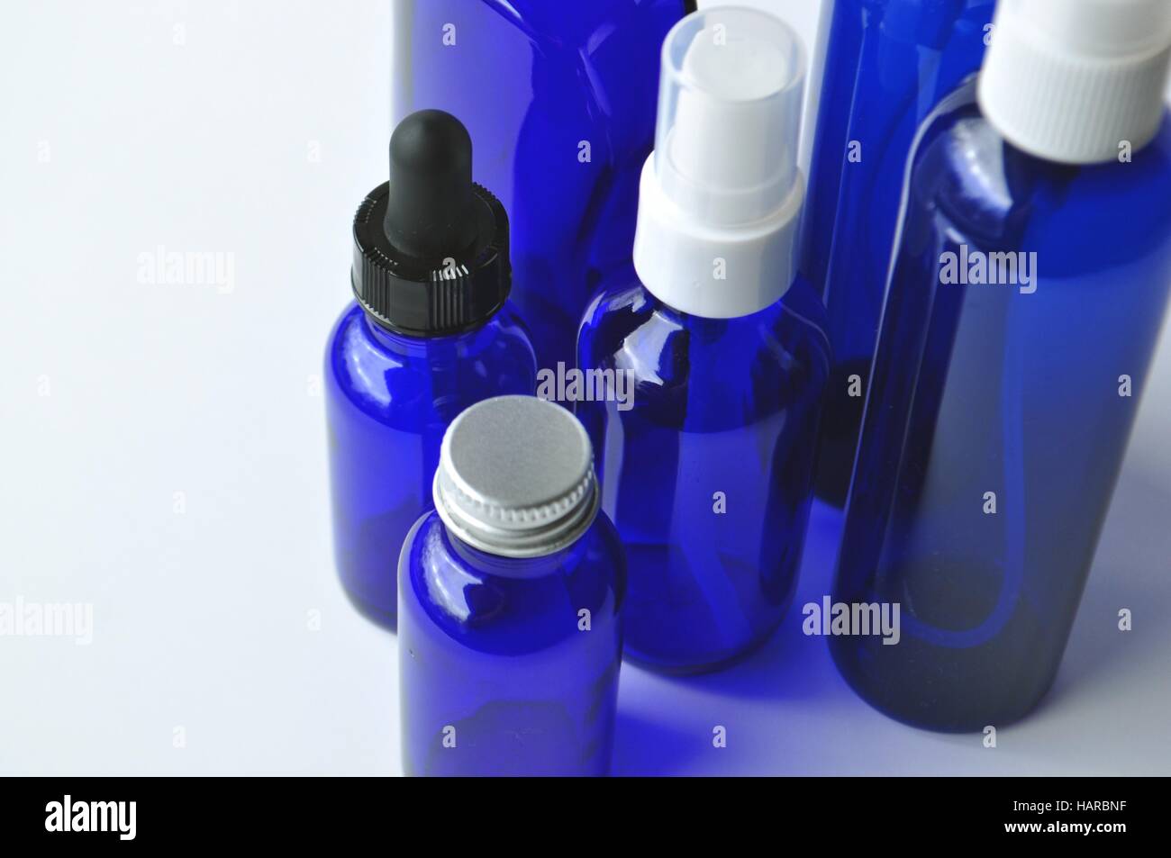Group of dark blue cosmetic glass bottles for essential oils ...