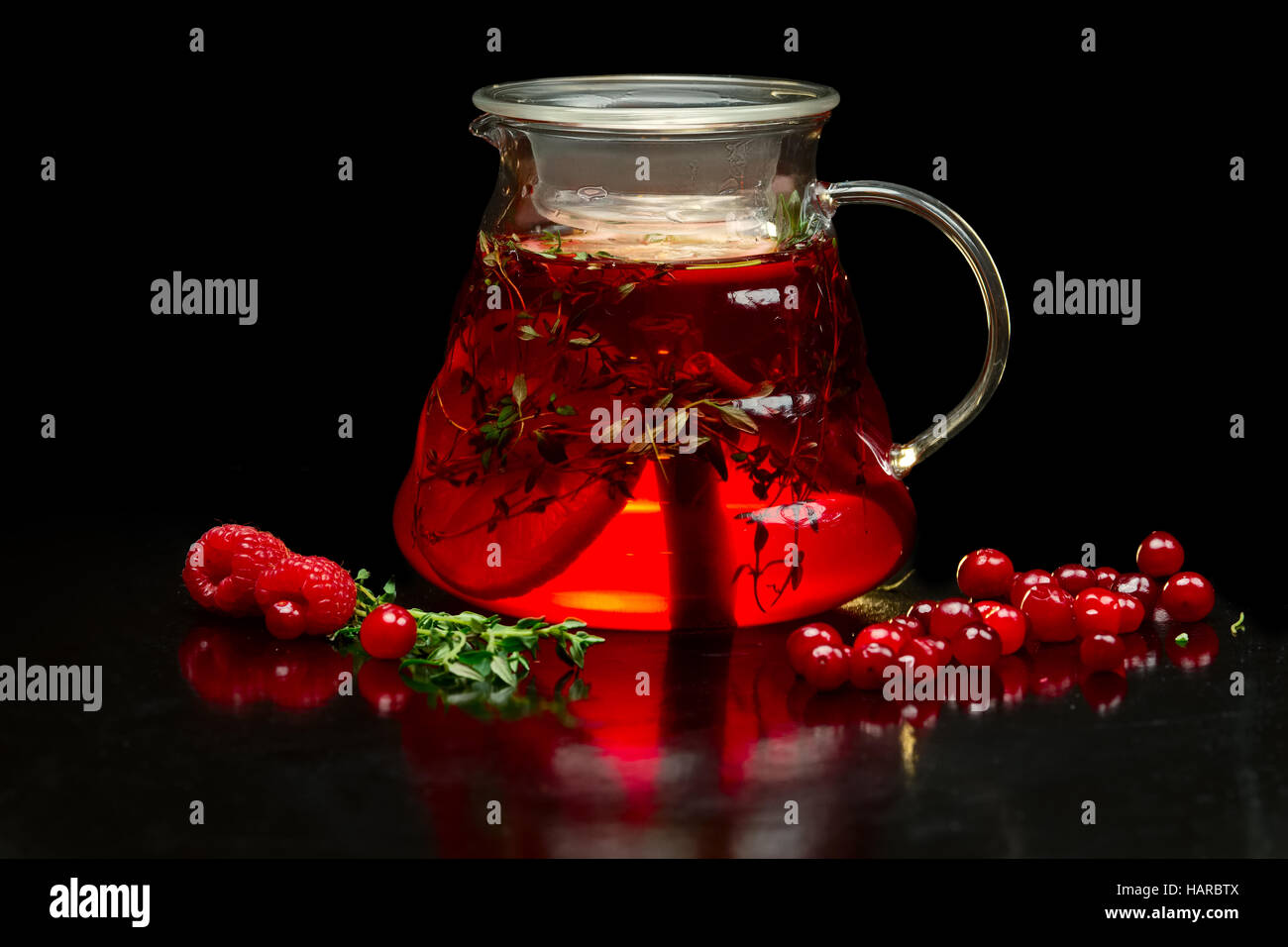 Transparent teapot of red tea with lemon raspberry with ingredients ...