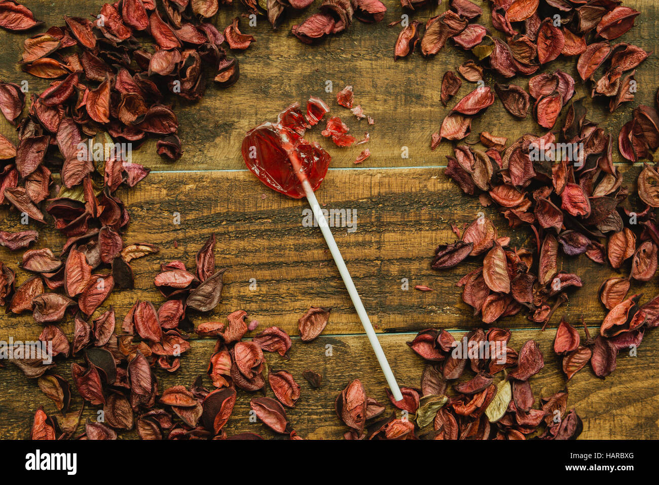 Broken red lollipo with heart shape on a wooden background Stock Photo ...