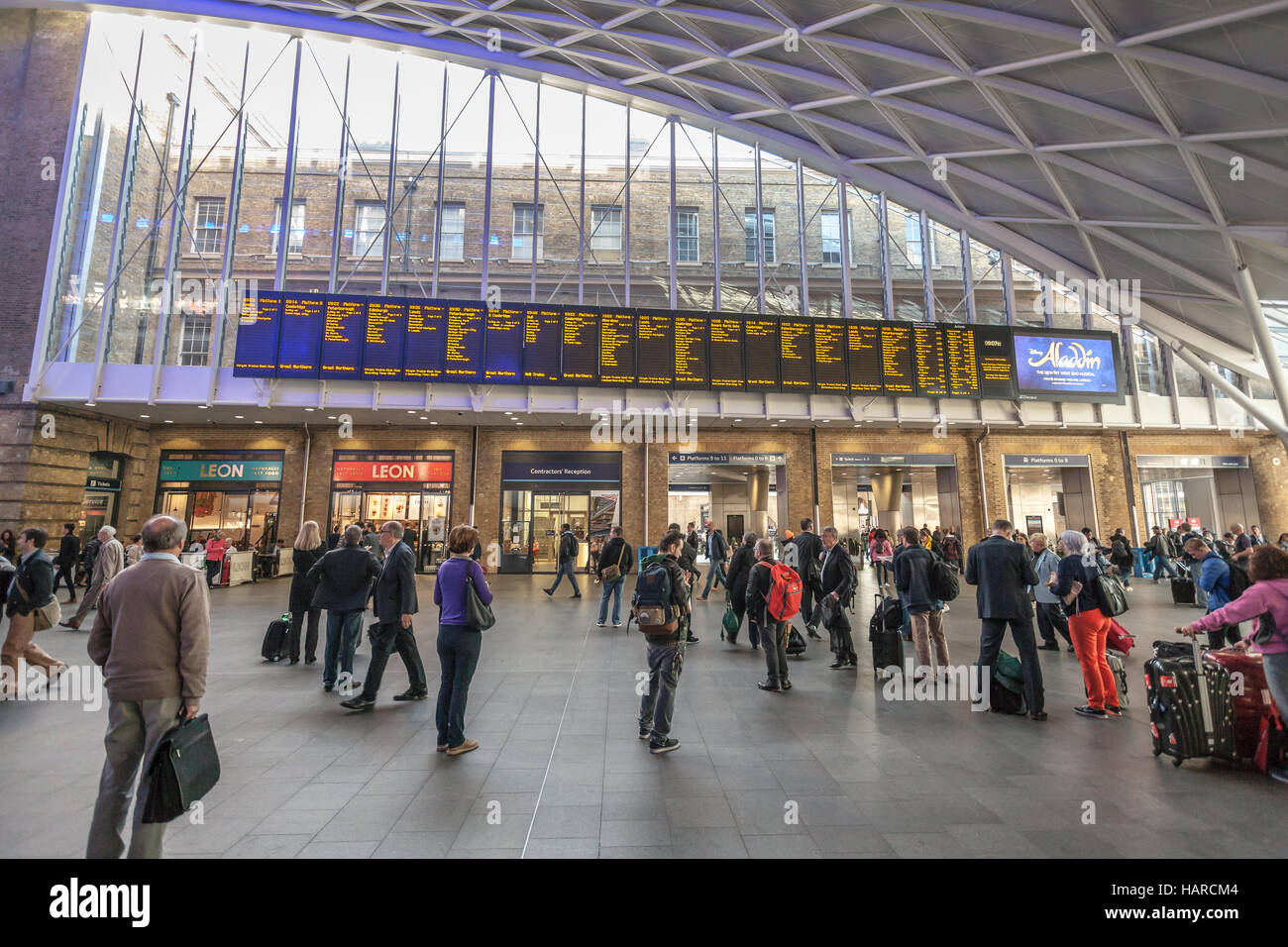 London people in front of the electronic panels with arrival and ...