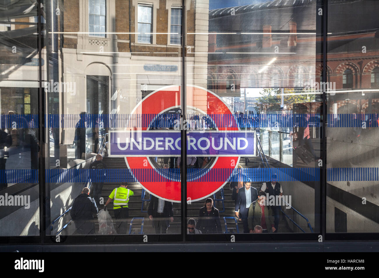 London Underground sign with people in background entering on the ...