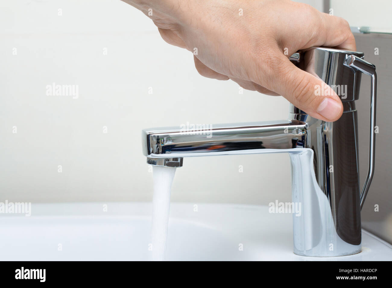 man hand on water tap Stock Photo - Alamy