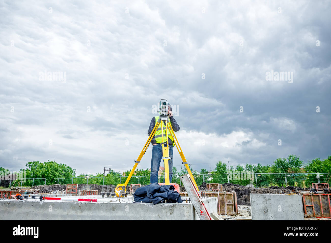 Surveyor engineer is measuring level on construction site. Surveyors ...