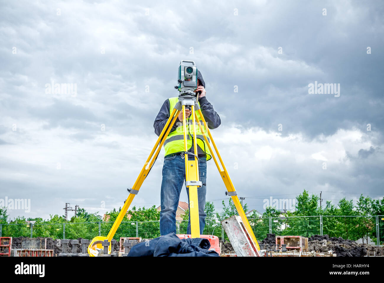 Surveyor engineer is measuring level on construction site. Surveyors ...