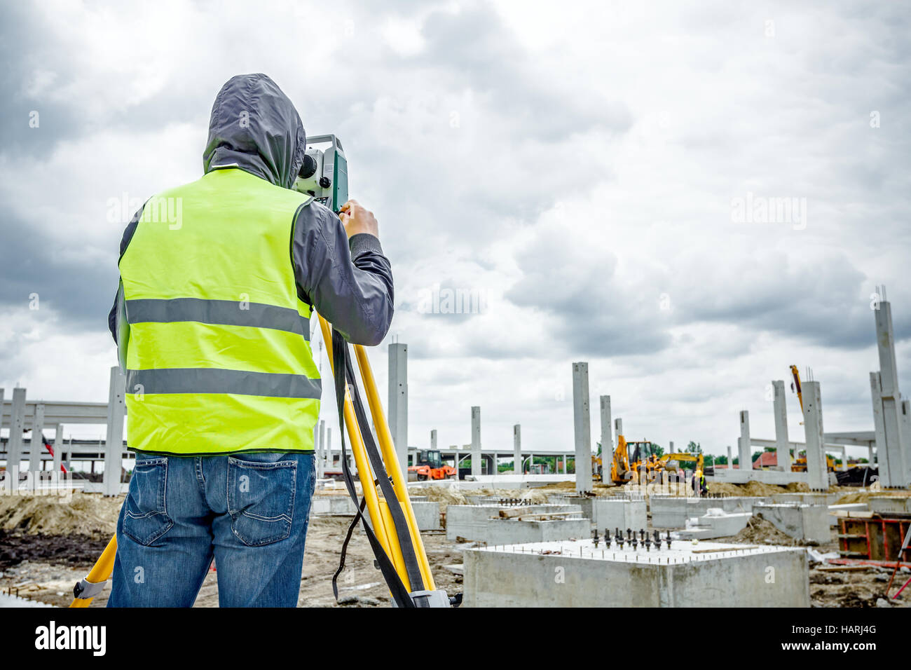 Surveyor engineer is measuring level on construction site. Surveyors ...