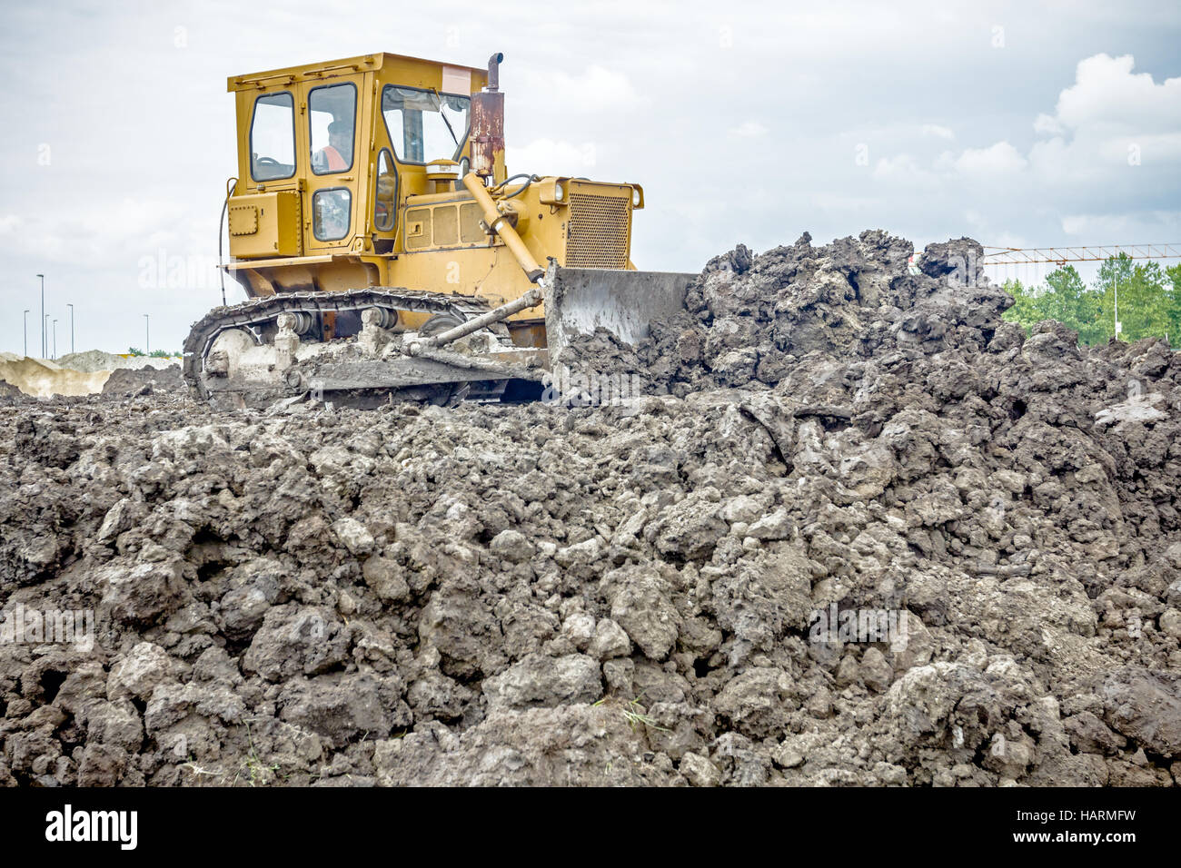 View on heavy bulldozer while he moving, leveling ground at ...