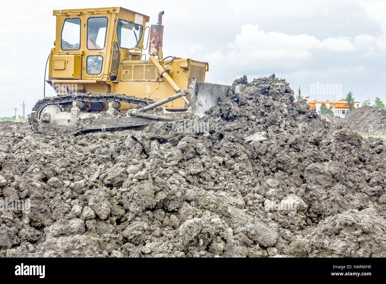 View on heavy bulldozer while he moving, leveling ground at ...