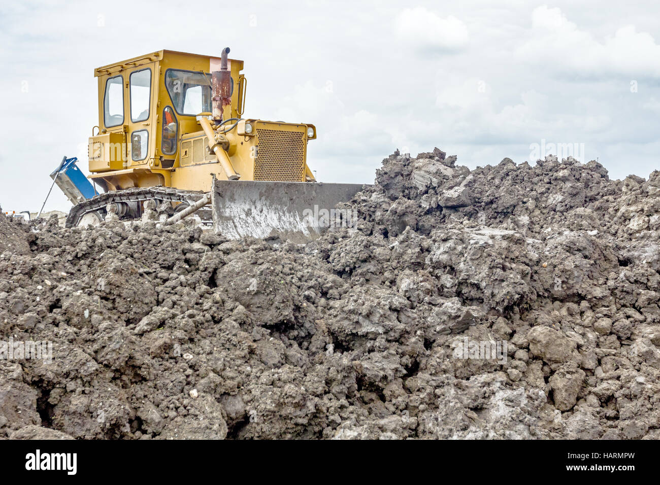 View on heavy bulldozer while he moving, leveling ground at ...