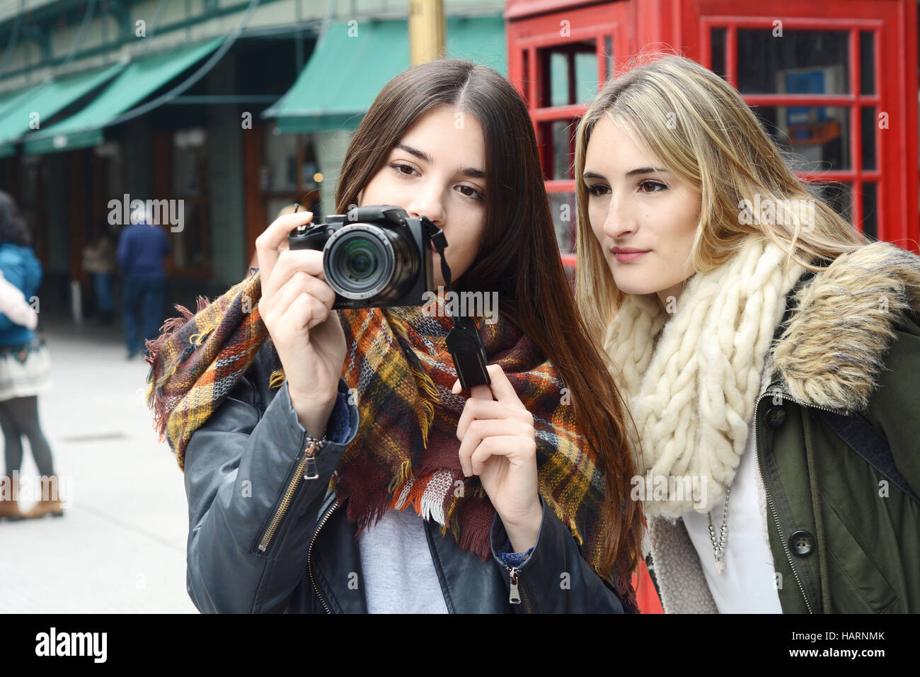 Portrait of two young tourists taking a photo with camera. Tourism ...