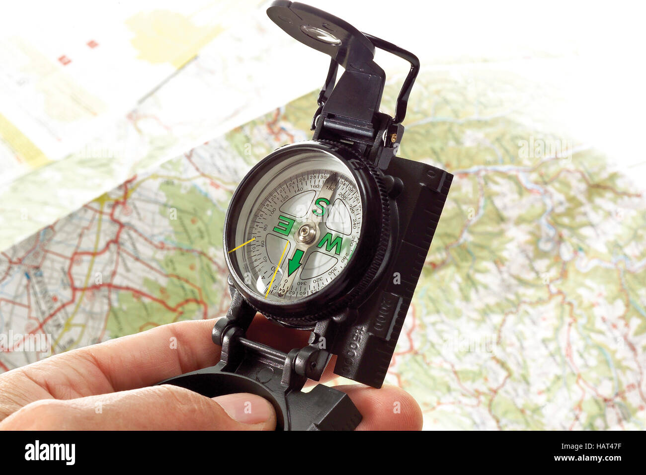 Hand holding a compass over a map Stock Photo - Alamy