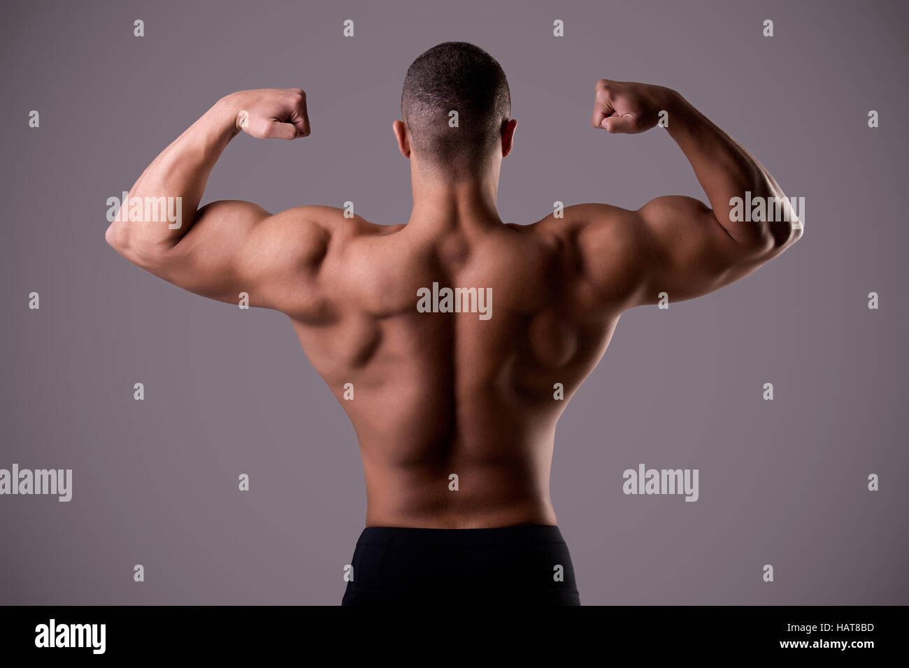 Bodybuilder doing a Back Double Biceps pose Stock Photo - Alamy