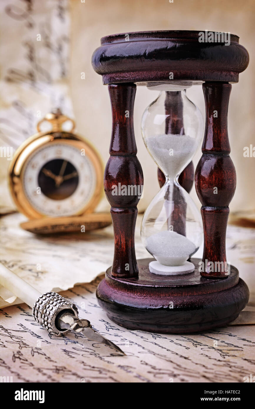 Vintage wooden hourglass, letters and feather pen. Retro concept Stock ...