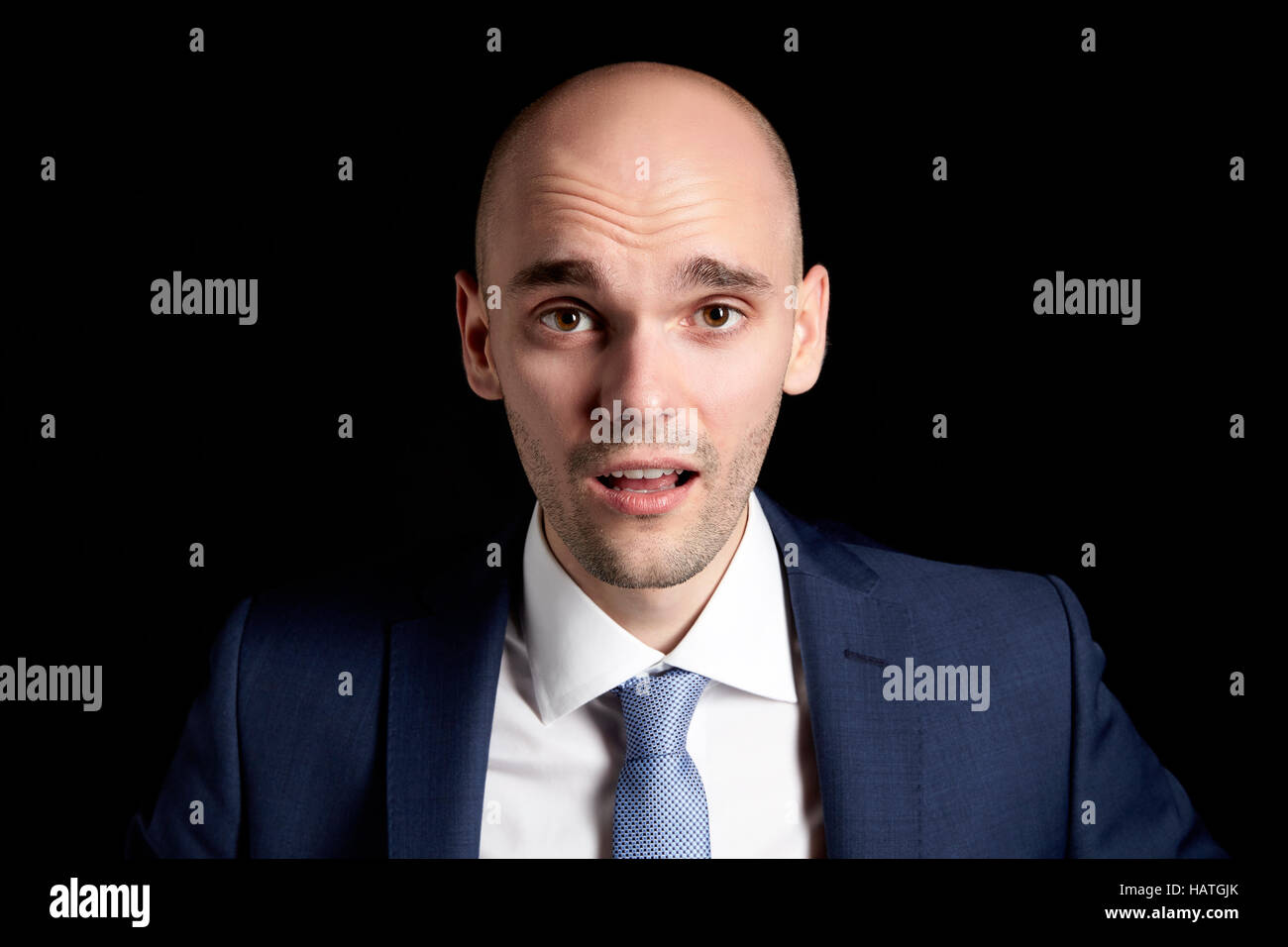 Unbelievable on young businessman face. Portrait on black background ...
