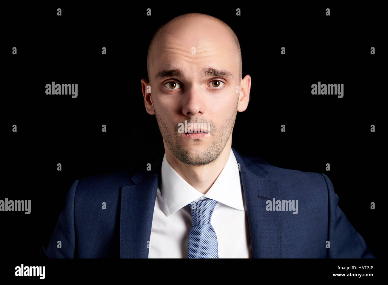 Unbelievable on young businessman face. Portrait on black background ...