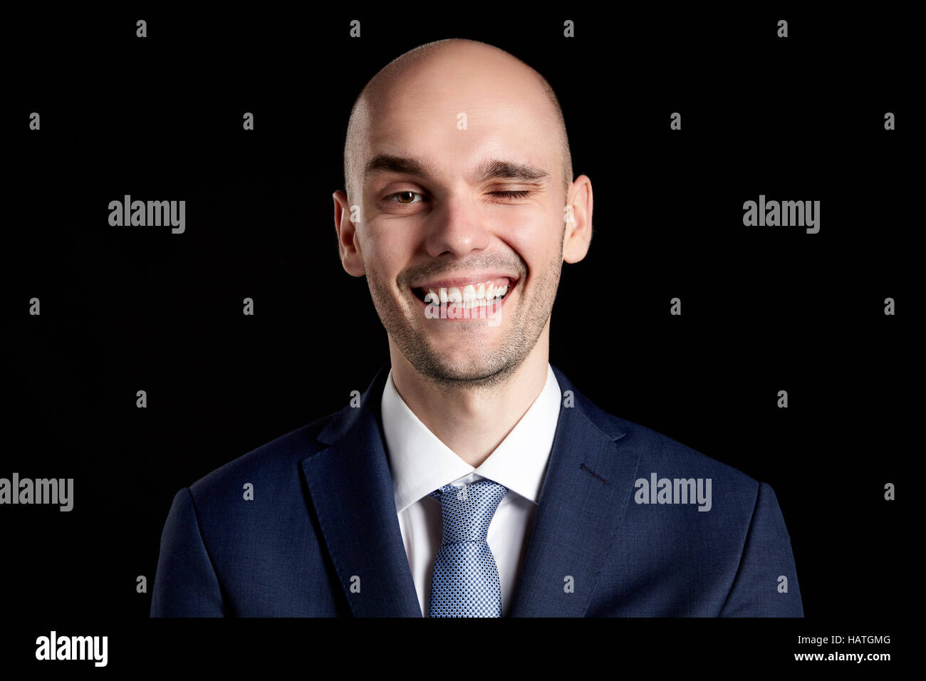 Studio portrait of young smiling man on black background Stock Photo ...