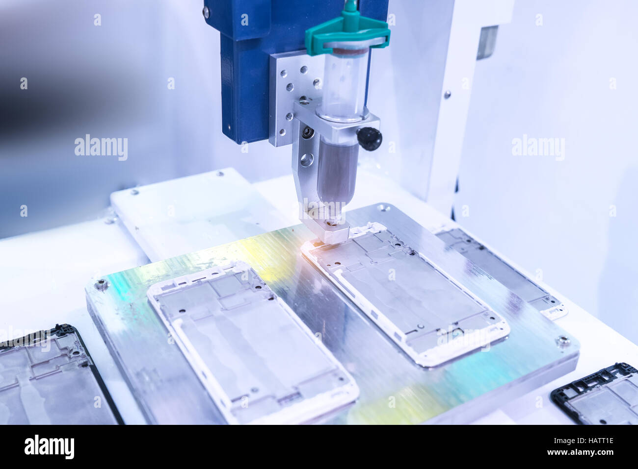 Robot holding glue syringe Injection on phone Stock Photo - Alamy