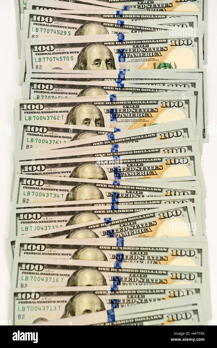 Many hundred dollar cash banknotes spread on white surface Stock Photo ...