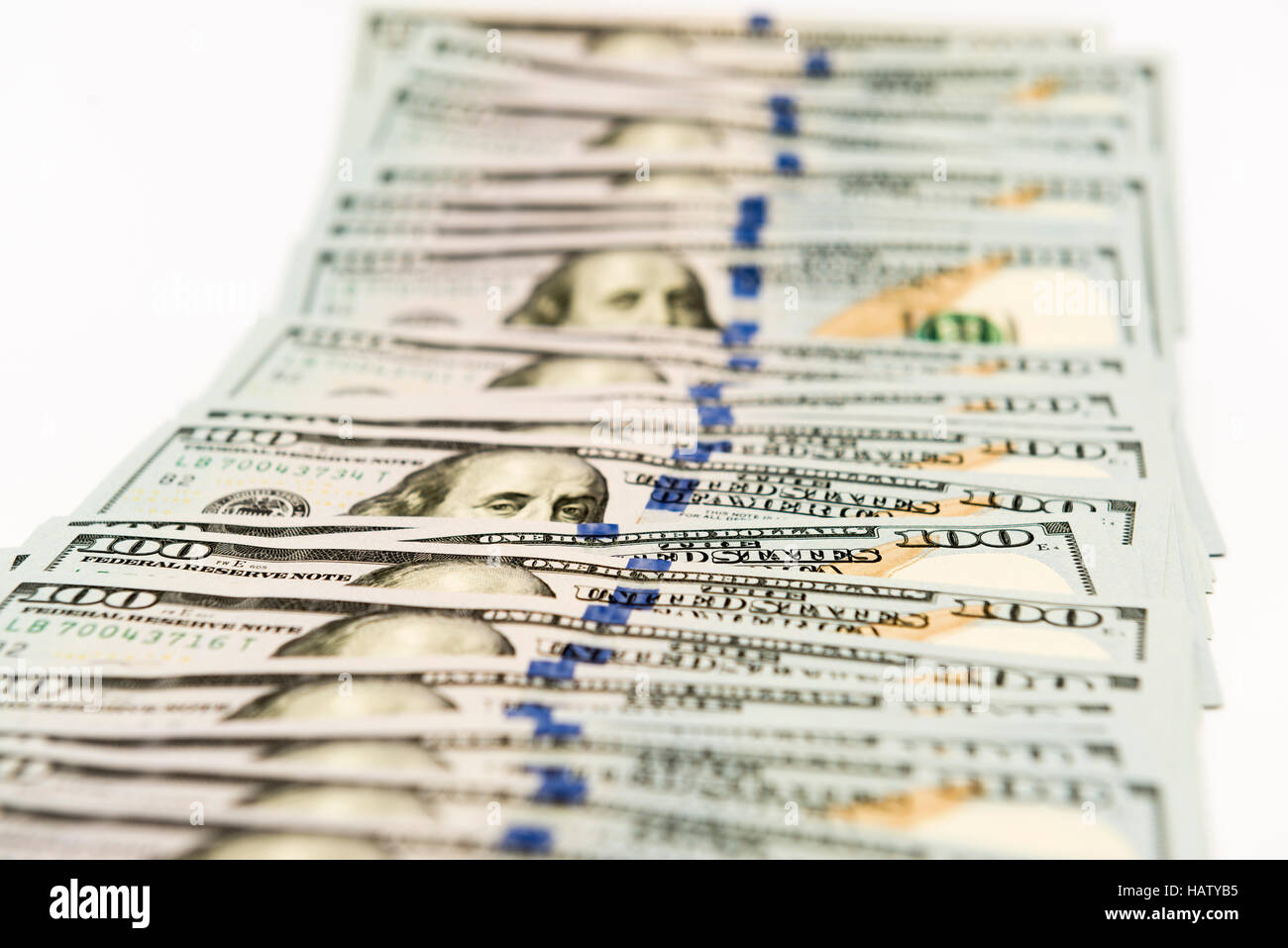 Many hundred dollar cash banknotes spread on white surface Stock Photo ...